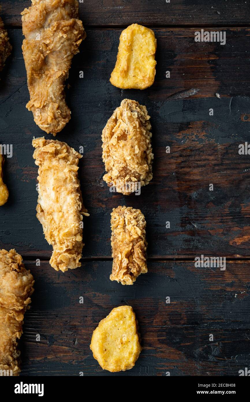 Crispy kentucky fried chicken cuts on dark wooden background, flat lay ...