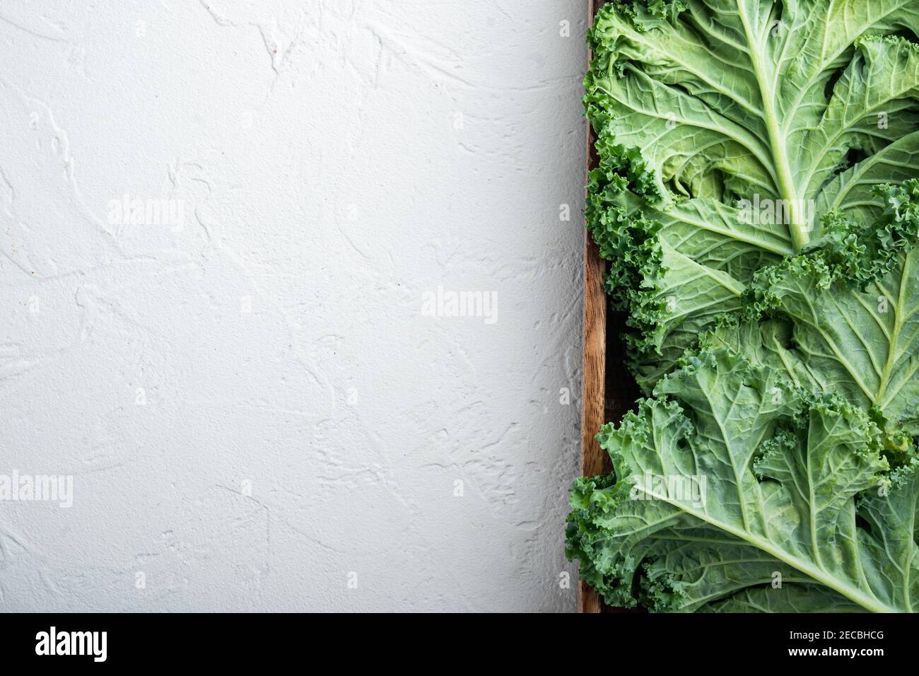 Fresh organic green kale leaves set, in wooden box, on white background ...