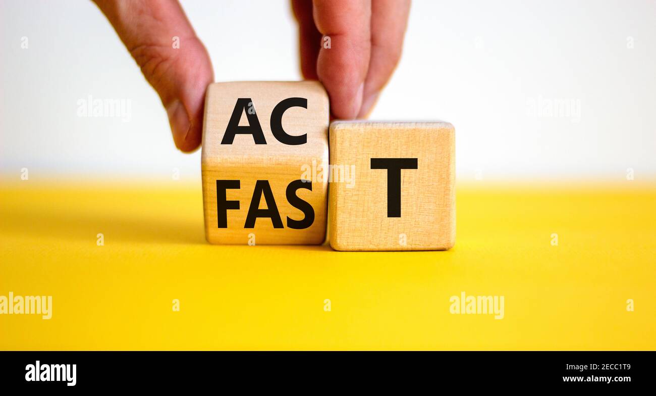 Time to act fast symbol. Businessman turns a wooden cube with words ...