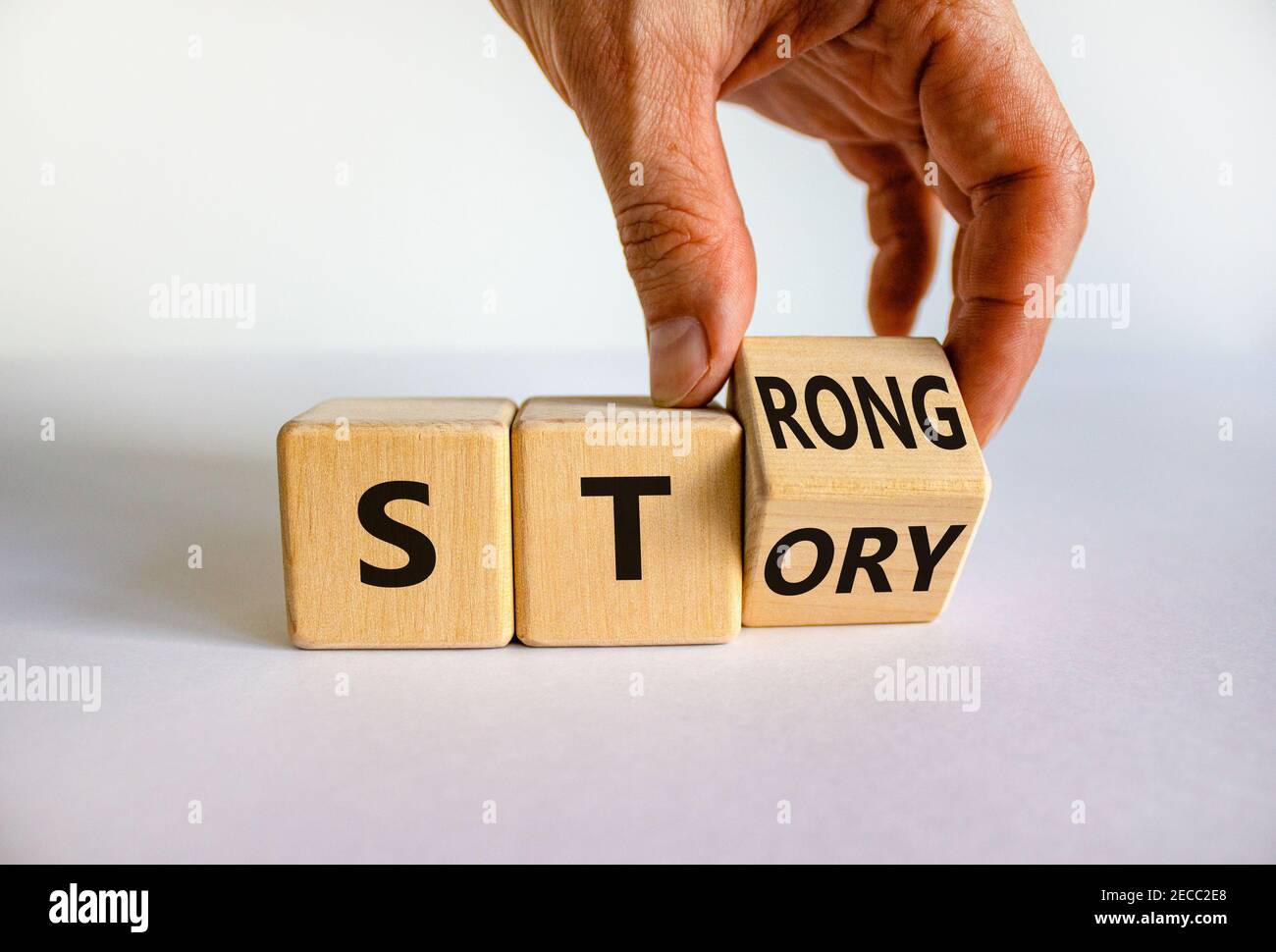 Strong story symbol. Businessman turns wooden cubes with words 'strong ...