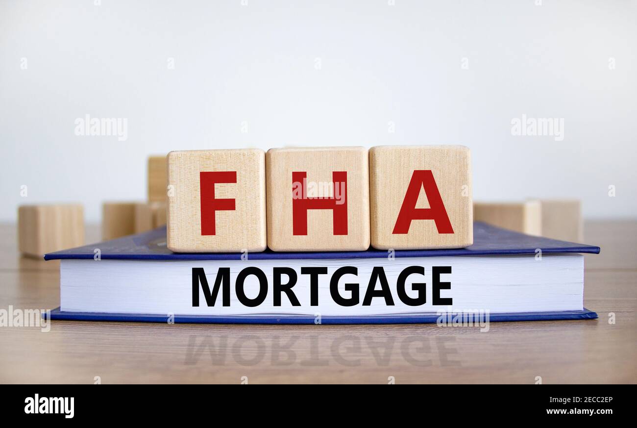 FHA mortgage symbol. Wooden blocks and book with words 'FHA mortgage ...