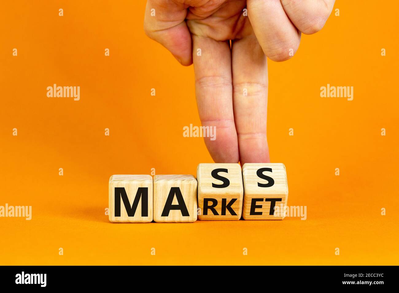 Mass market symbol. Businessman flips wooden cubes with words 'mass ...
