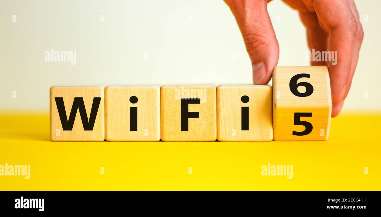 WiFi 5 or 6 symbol. Businessman turns a wooden cube and changes the ...