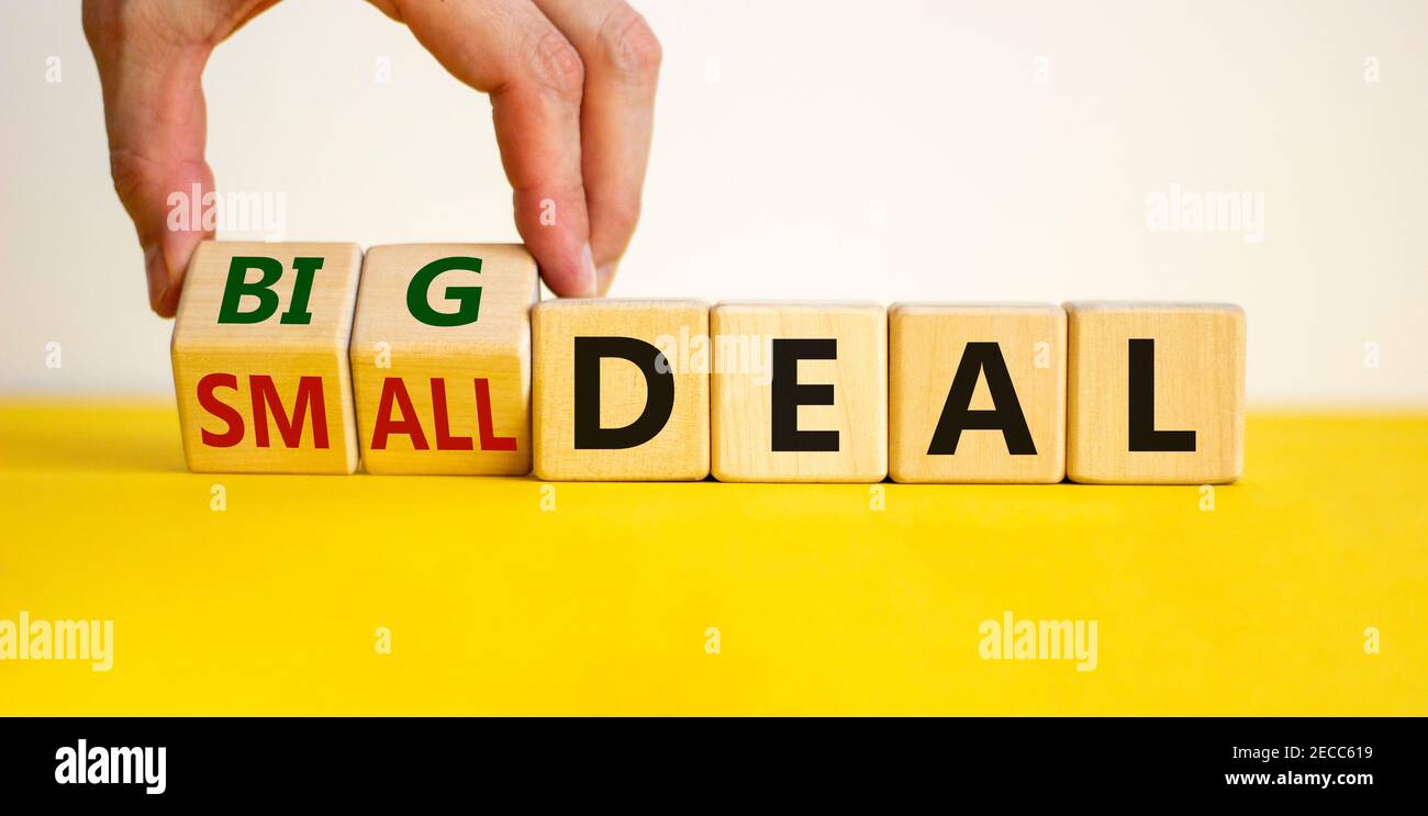 Big or small deal symbol. Businessman turns a wooden cube and changes ...