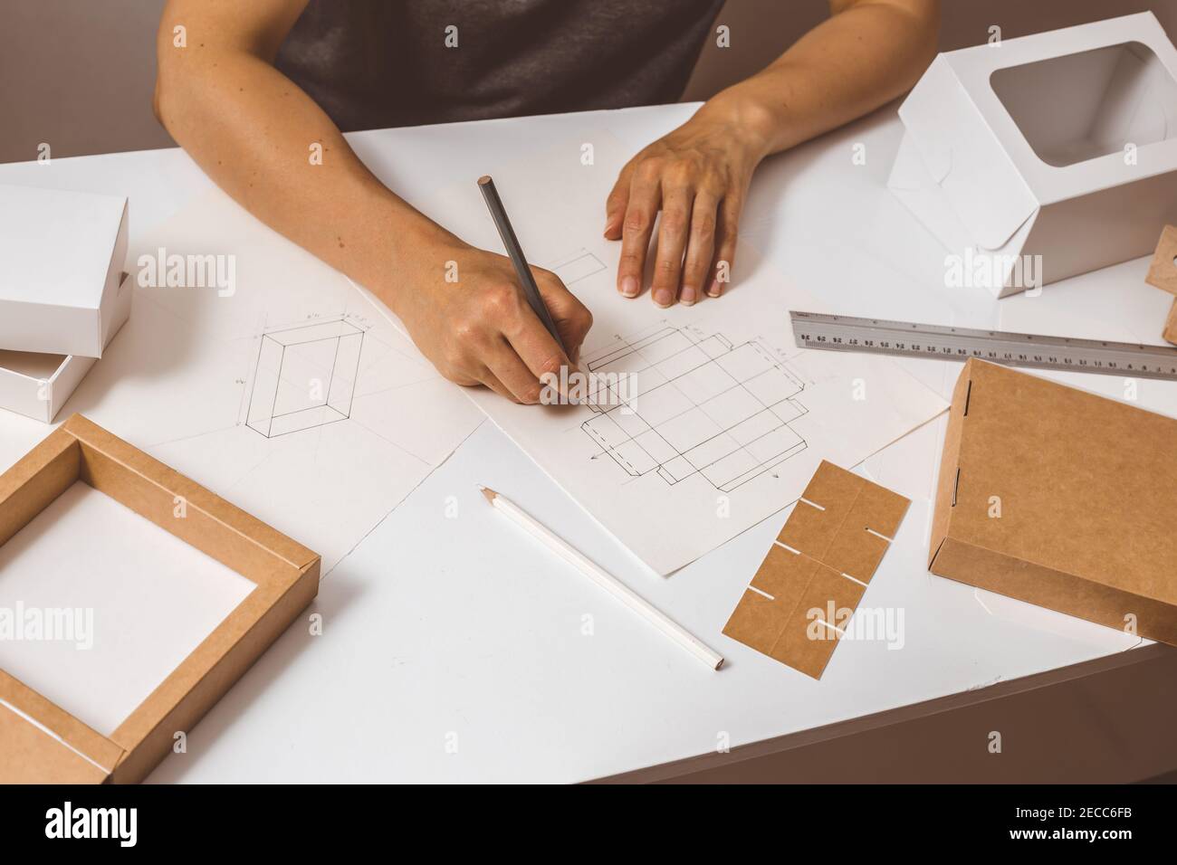 Designer draws a mockup for crafting cardboard box. Development of ...