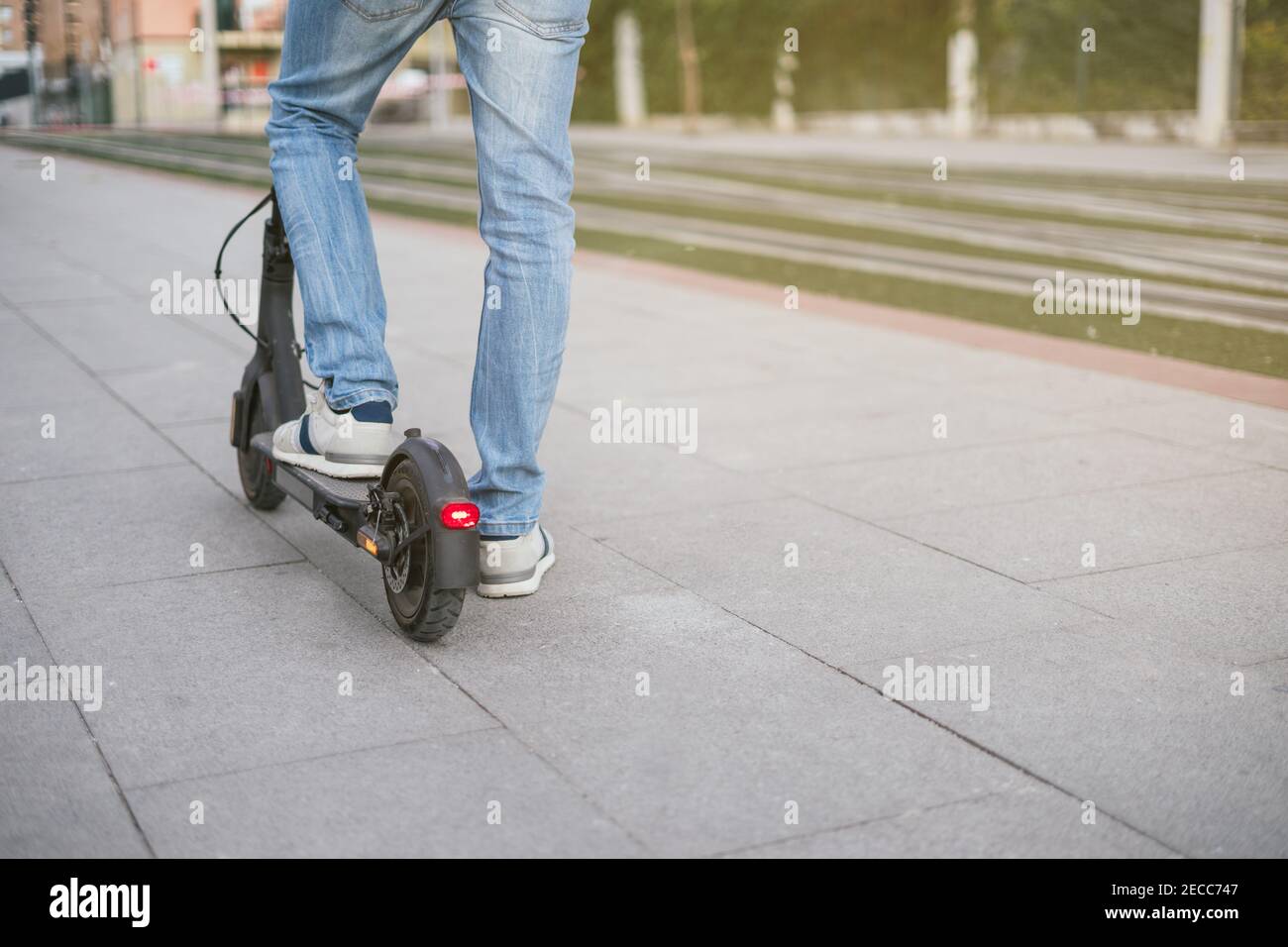 Close-up of a person's feet on an electric scooter from behind Stock ...