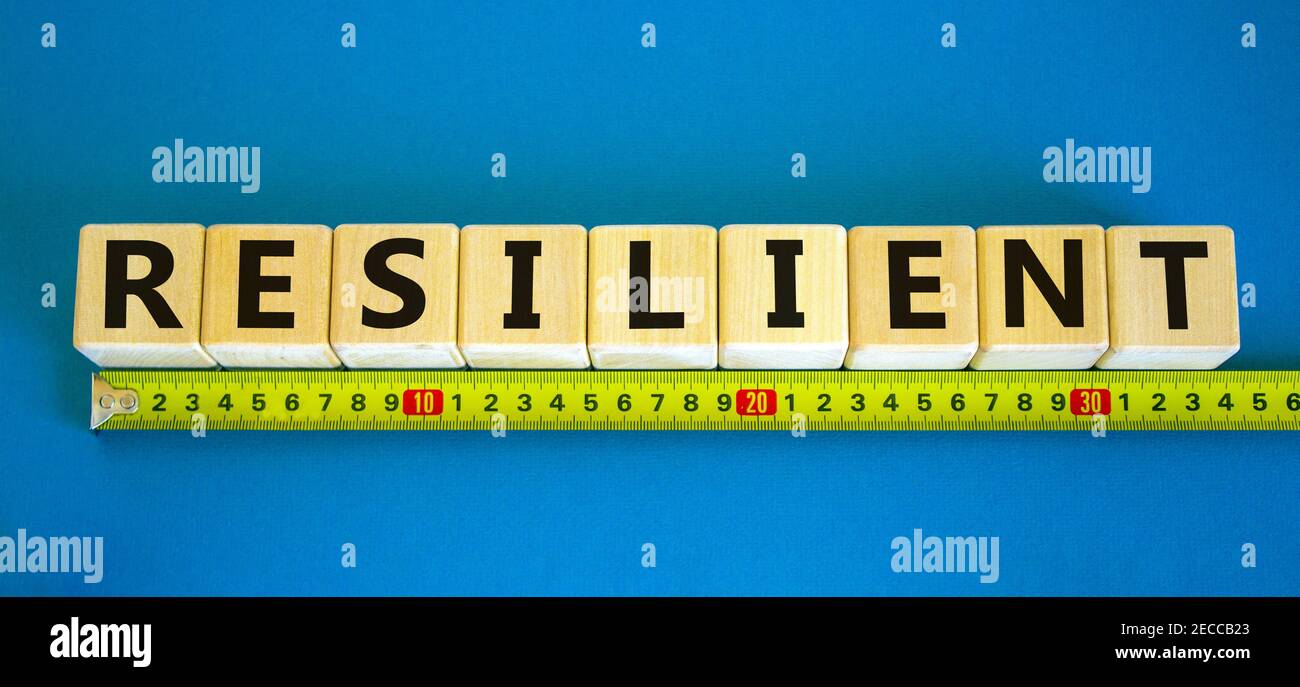 Resilient symbol. Resilient word on wooden cubes arranged behind the ...
