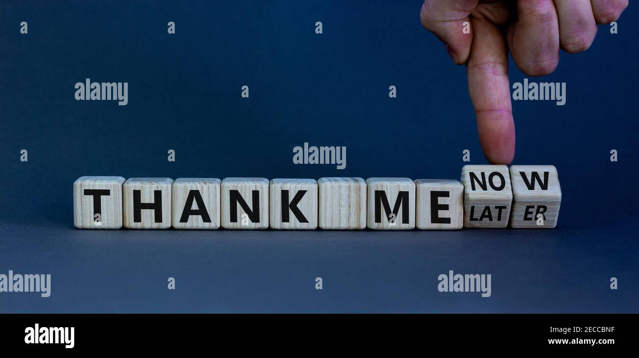 Thank me now or later symbol. Businessman turns cubes and changes words ...