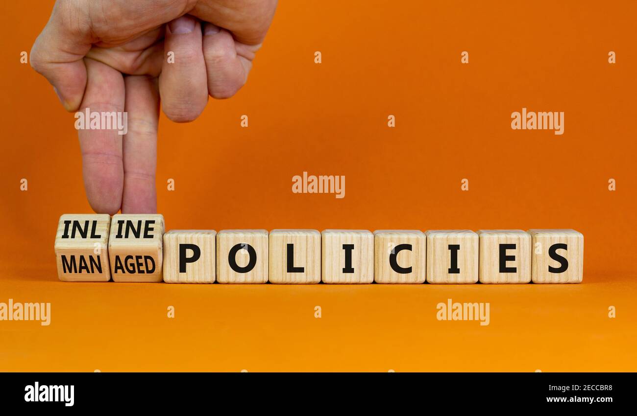 Inline or managed policies symbol. Businessman turns wooden cubes ...