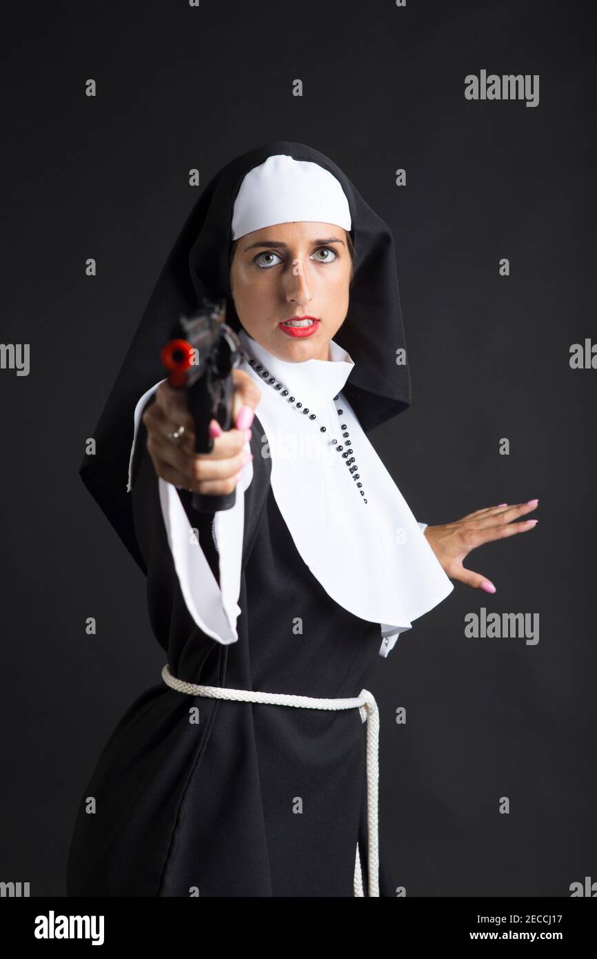 Portrait of a disguised nun on black background Stock Photo - Alamy
