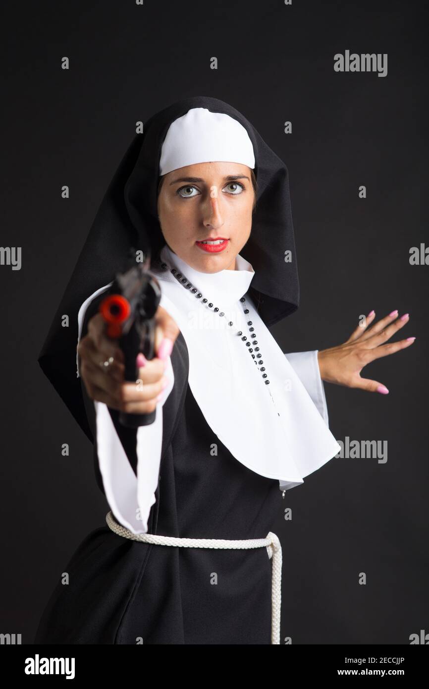 Portrait of a disguised nun on black background Stock Photo - Alamy
