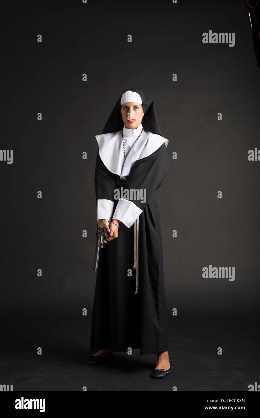 Portrait of a disguised nun on black background Stock Photo - Alamy