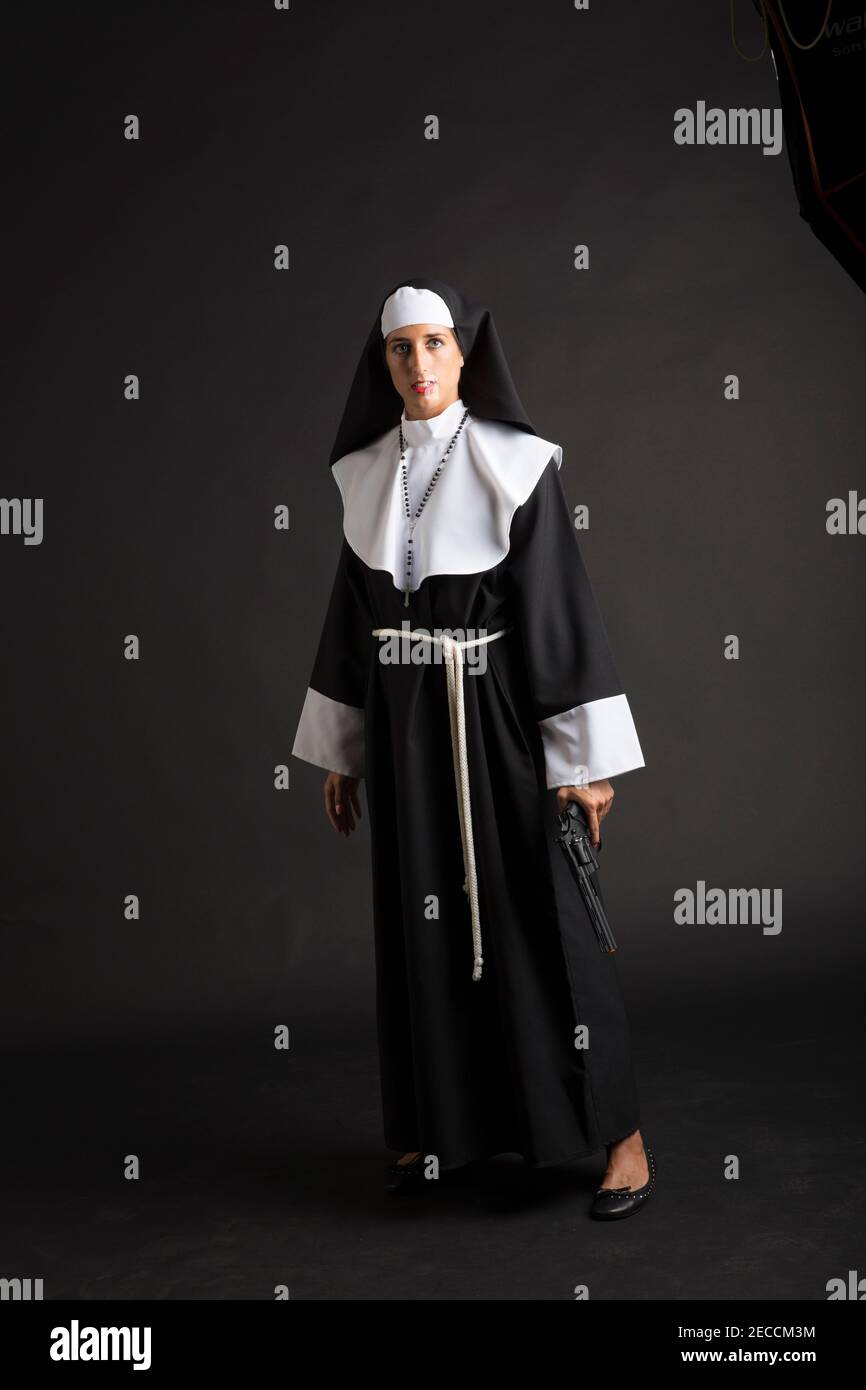 Portrait of a disguised nun on black background Stock Photo - Alamy