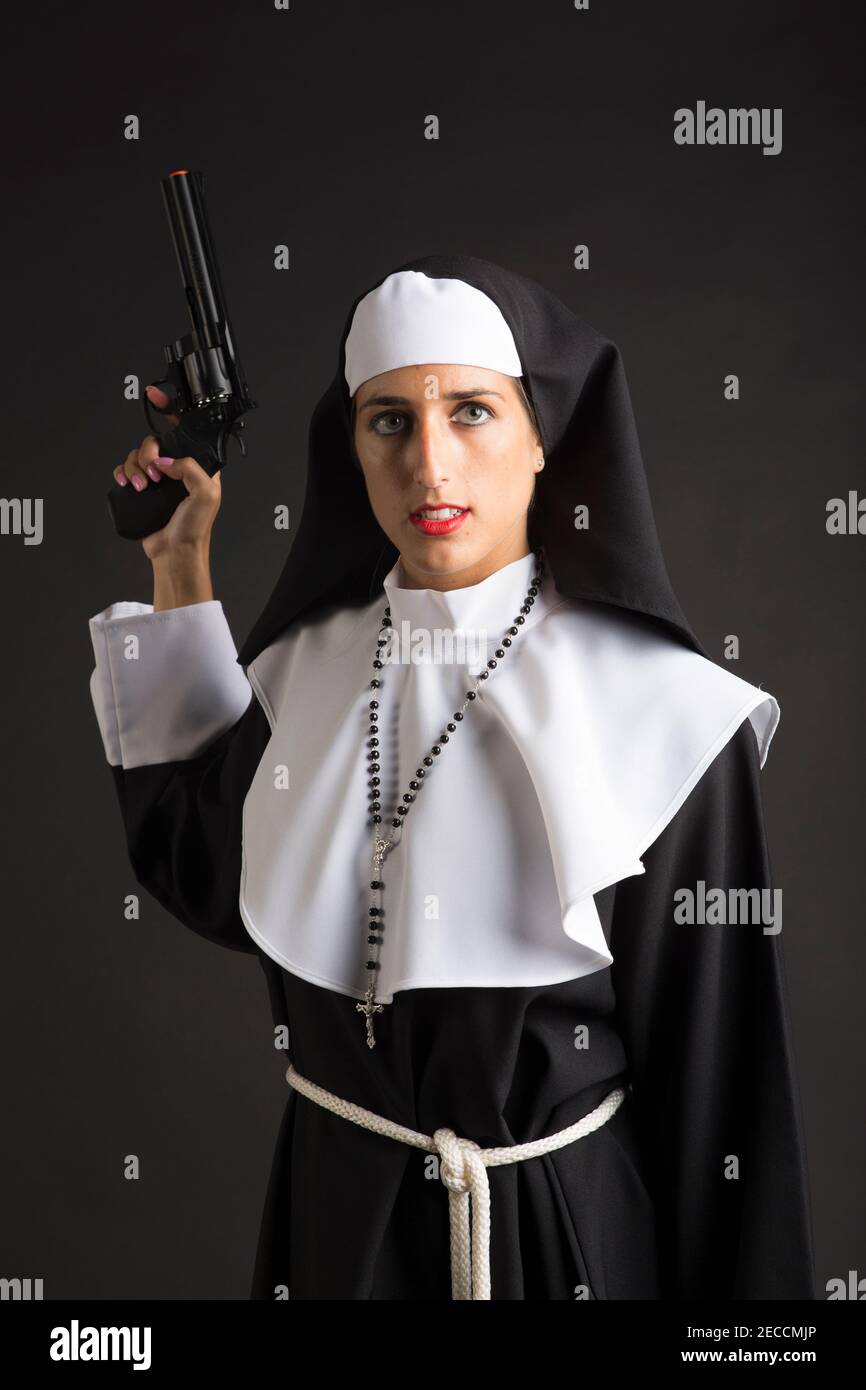 Portrait of a disguised nun on black background Stock Photo - Alamy