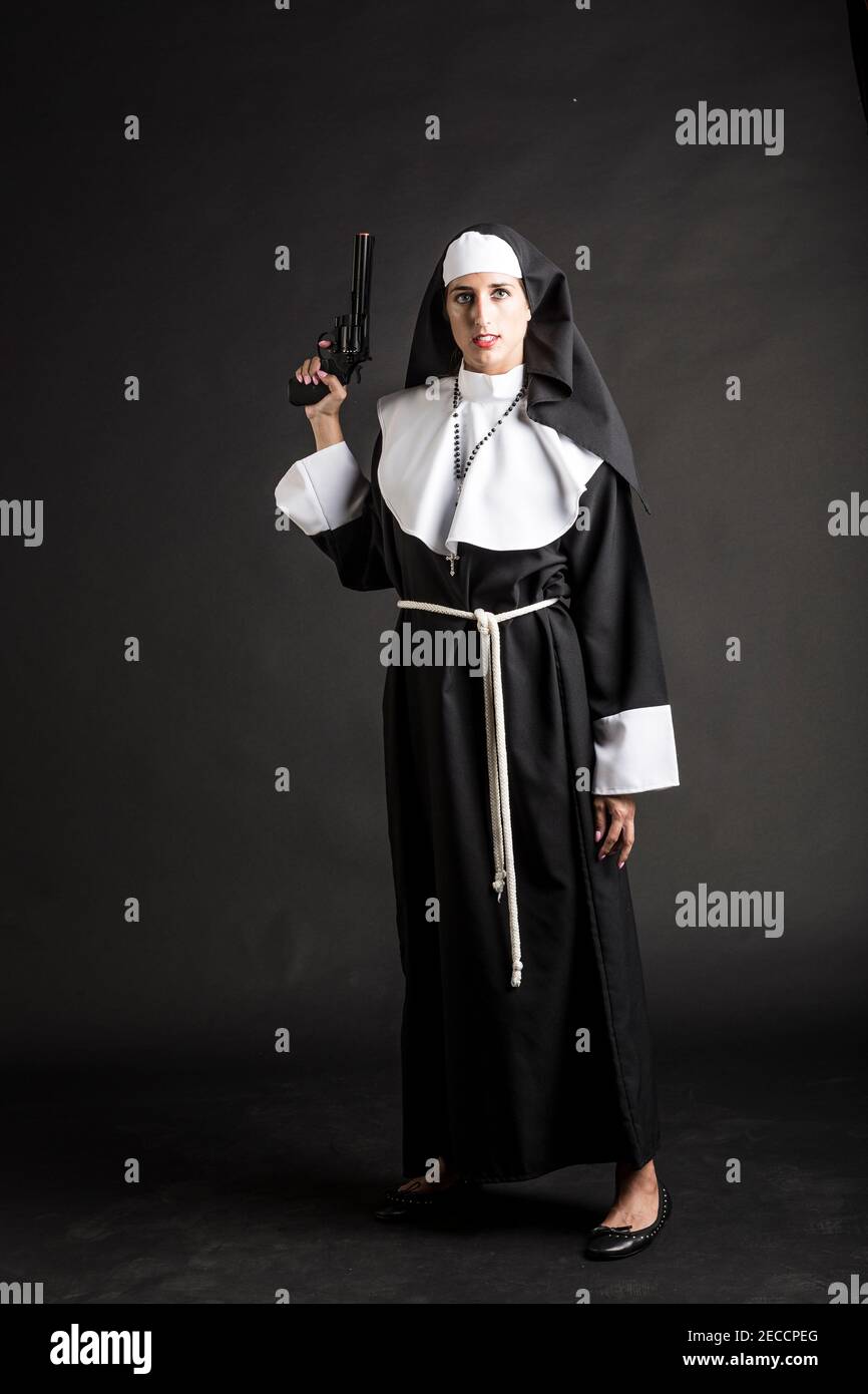 Portrait of a disguised nun on black background Stock Photo - Alamy