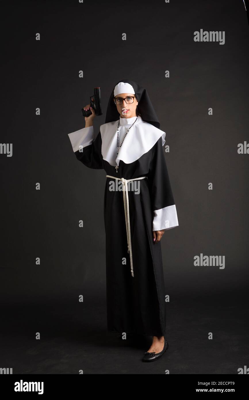 Portrait of a disguised nun on black background Stock Photo - Alamy