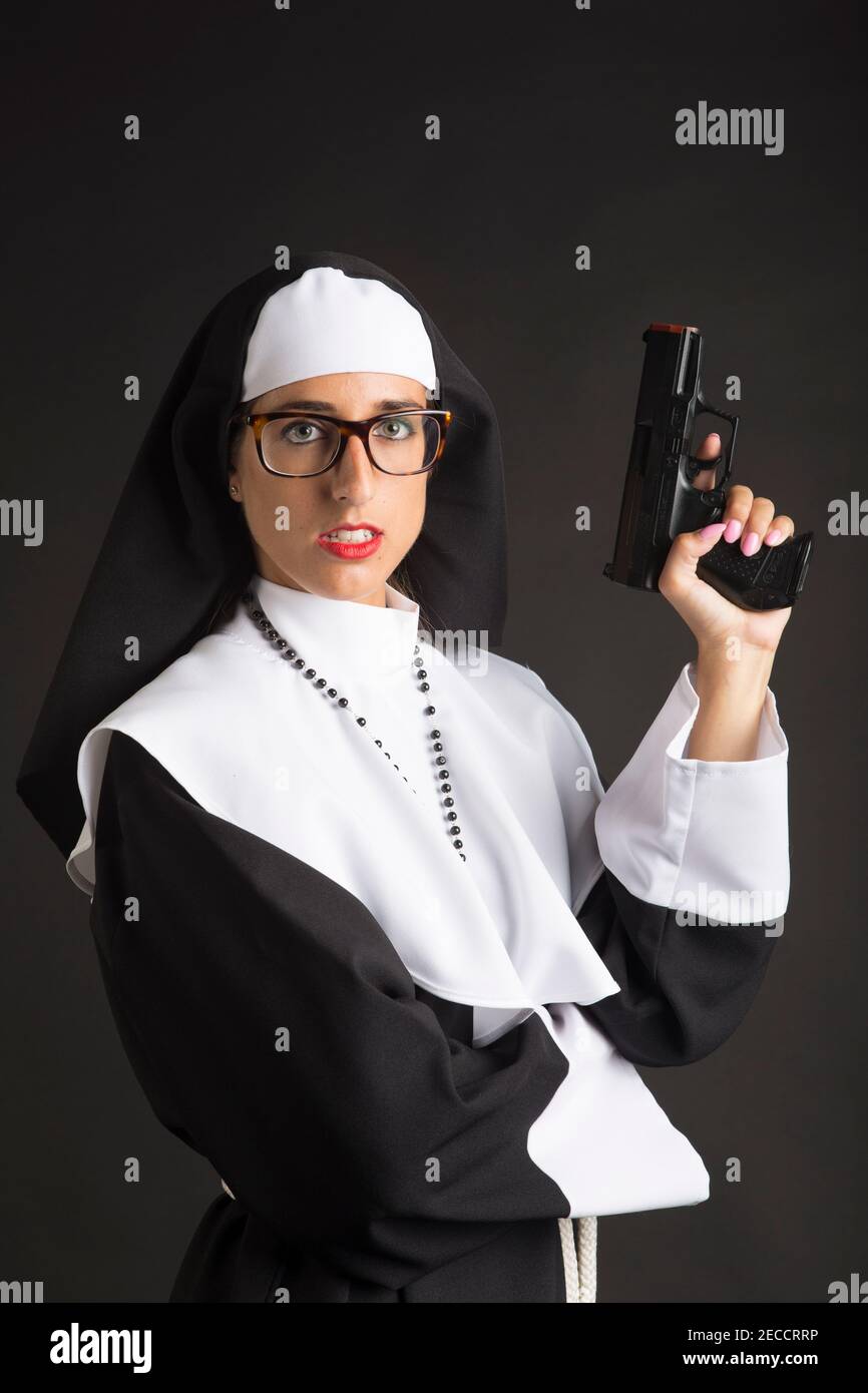 Portrait of a disguised nun on black background Stock Photo - Alamy