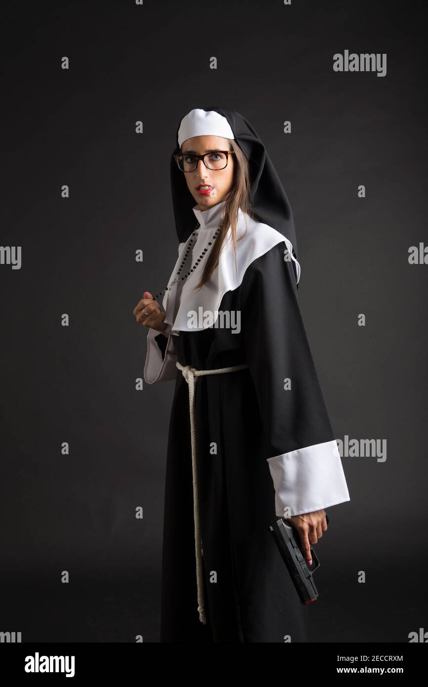 Portrait of a disguised nun on black background Stock Photo - Alamy