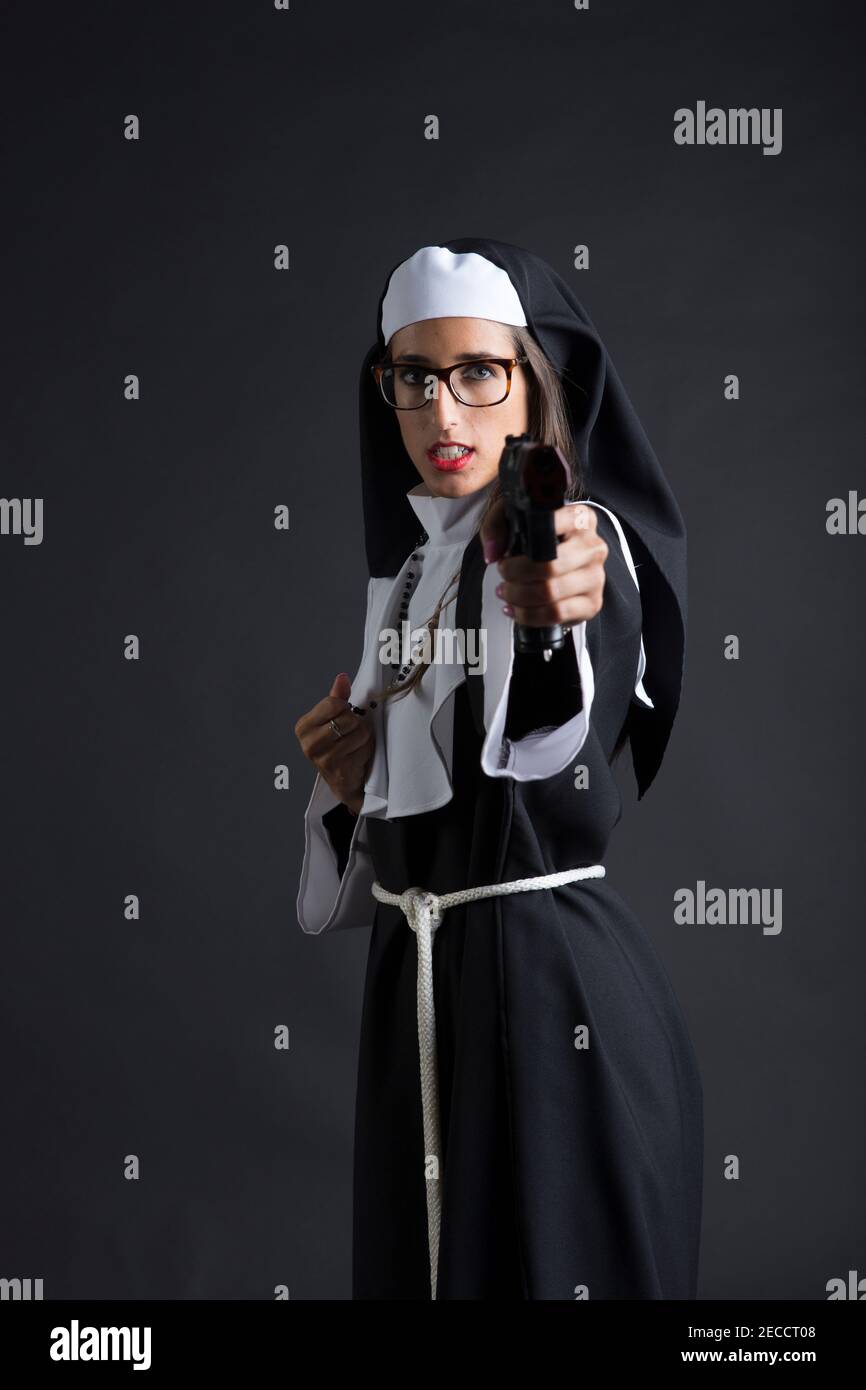 Portrait of a disguised nun on black background Stock Photo - Alamy