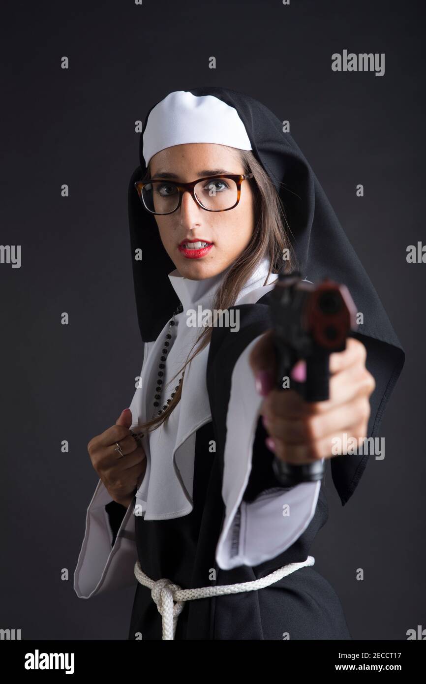 Portrait of a disguised nun on black background Stock Photo - Alamy