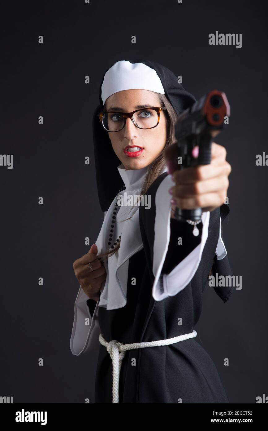 Portrait of a disguised nun on black background Stock Photo - Alamy