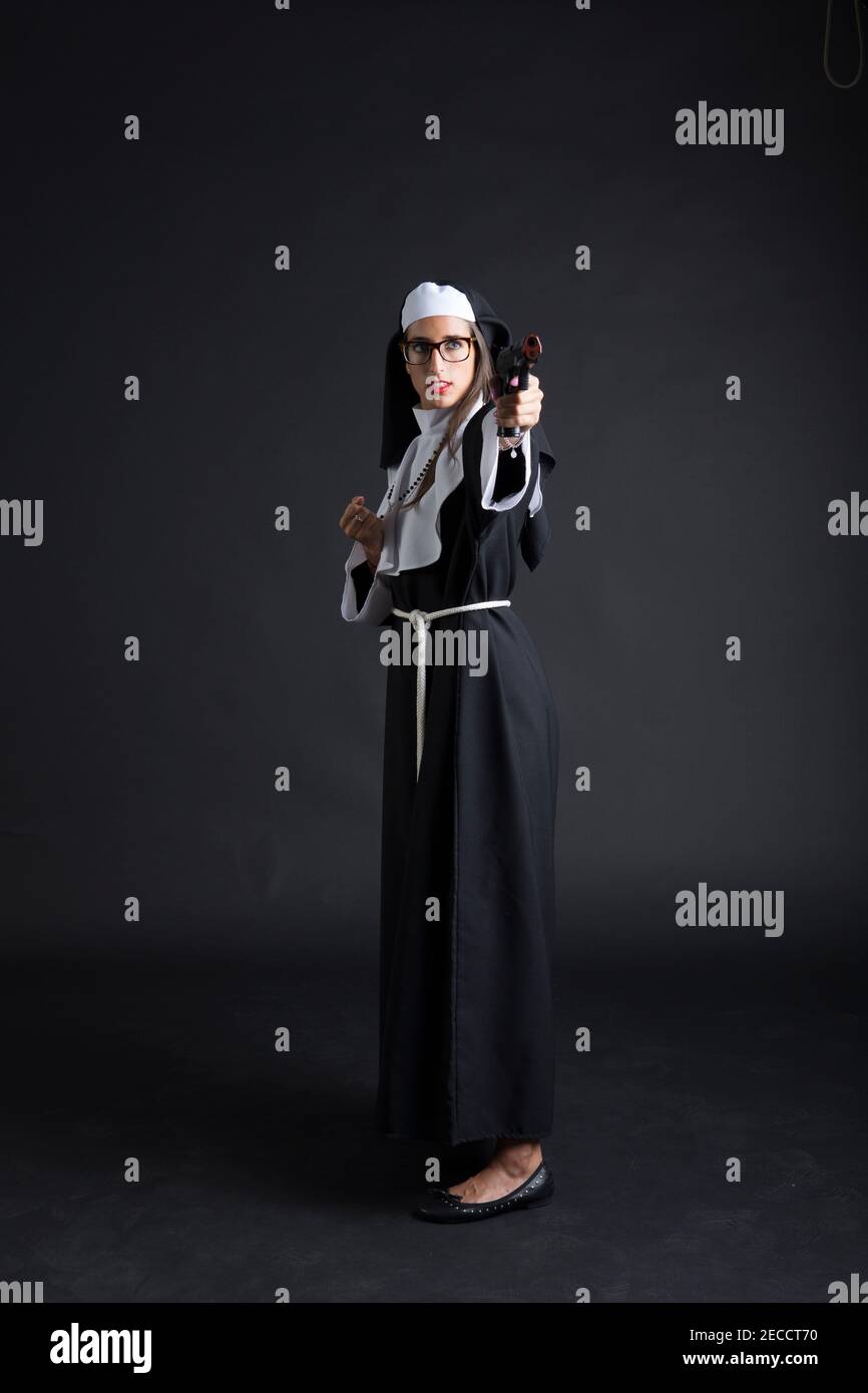 Portrait of a disguised nun on black background Stock Photo - Alamy