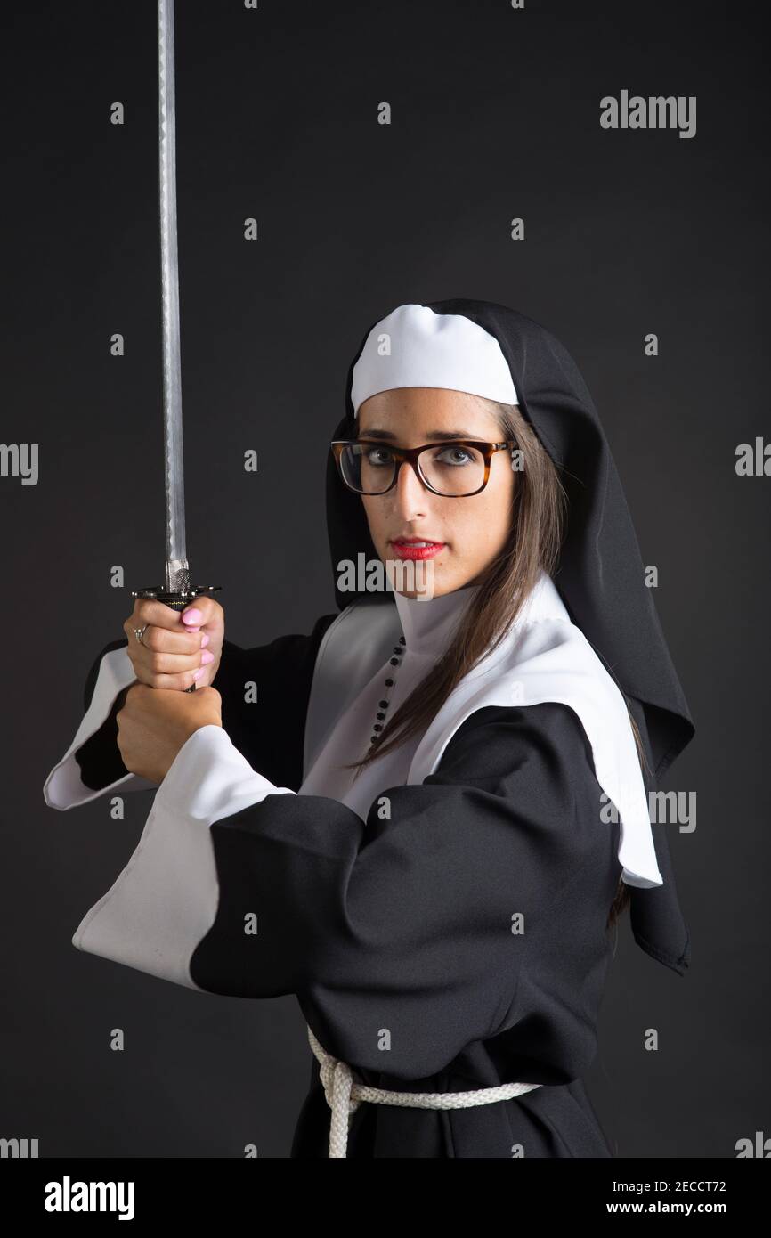 Portrait of a disguised nun on black background Stock Photo - Alamy