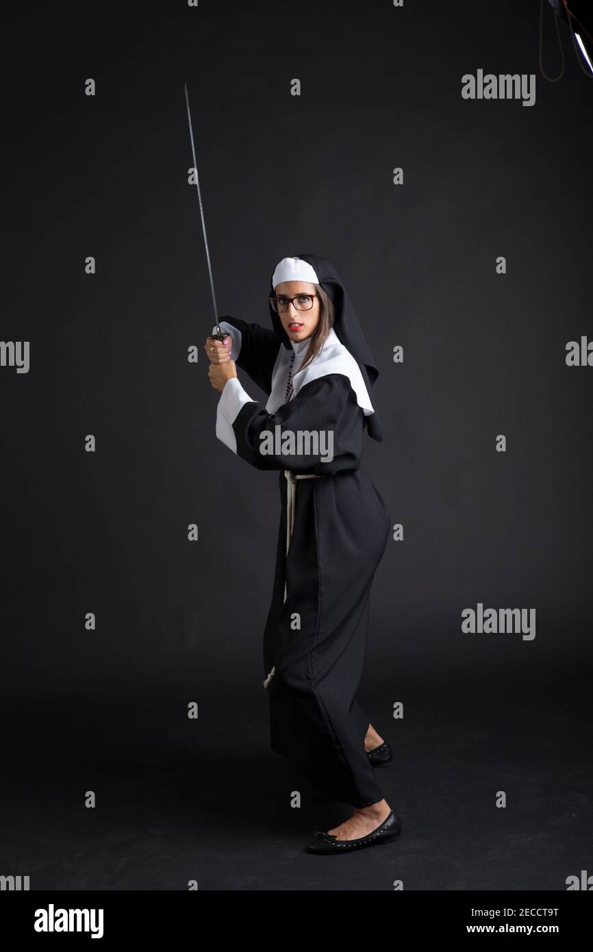 Portrait of a disguised nun on black background Stock Photo - Alamy