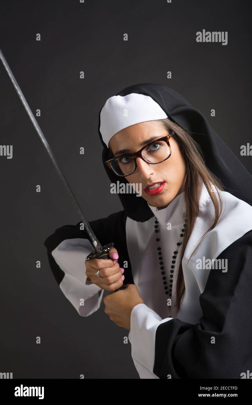 Portrait of a disguised nun on black background Stock Photo - Alamy
