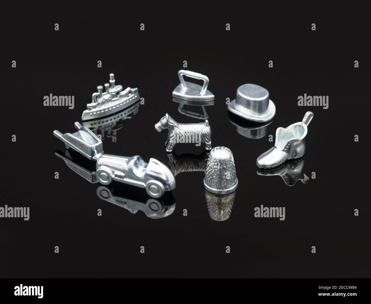 High angle shot of small silver toys isolated on a black background ...