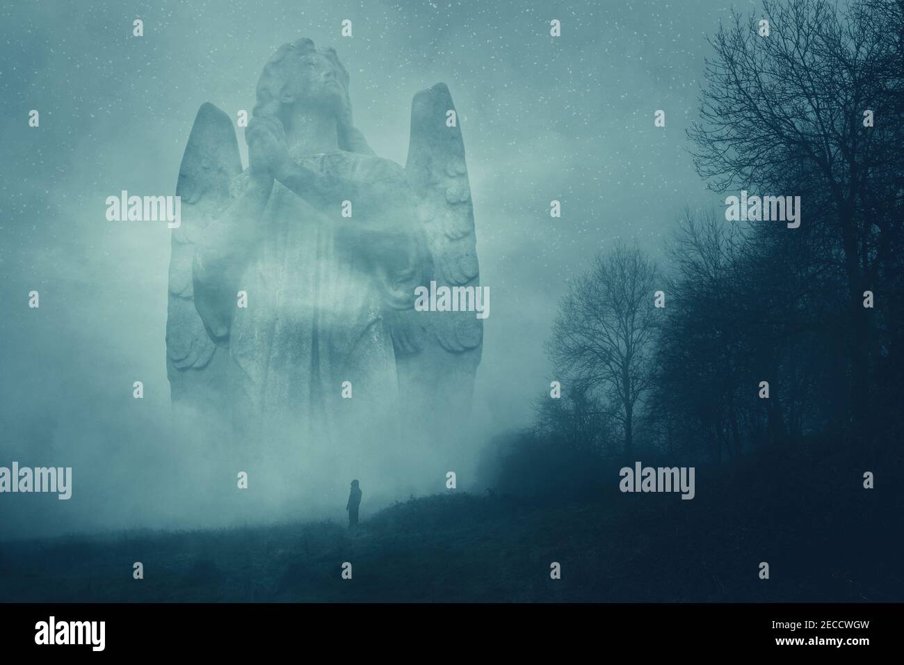 A ghostly giant statue of a graveyard angel in the countrtyside. On an ...