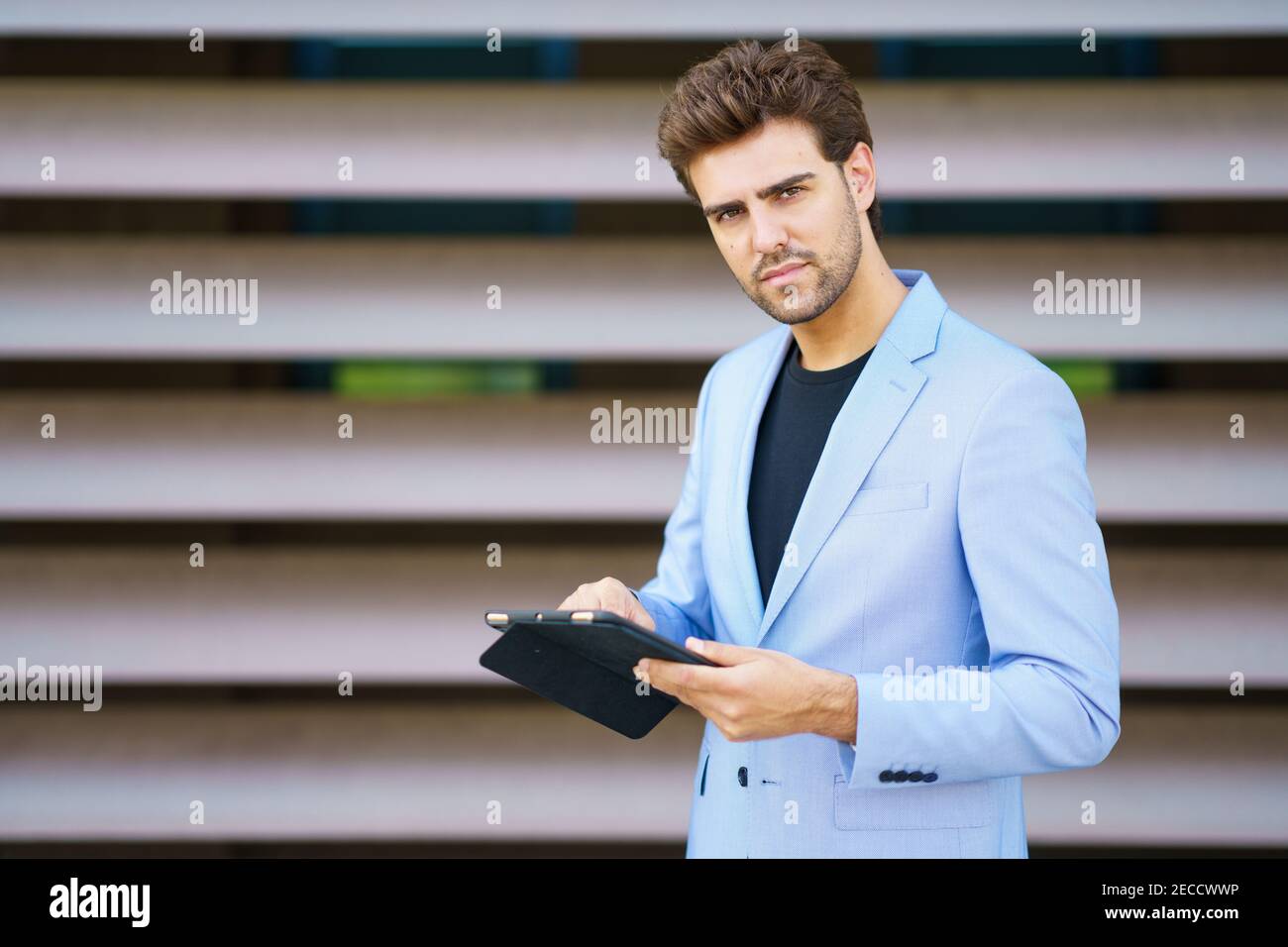 Businessman using a digital tablet near an office building Stock Photo ...