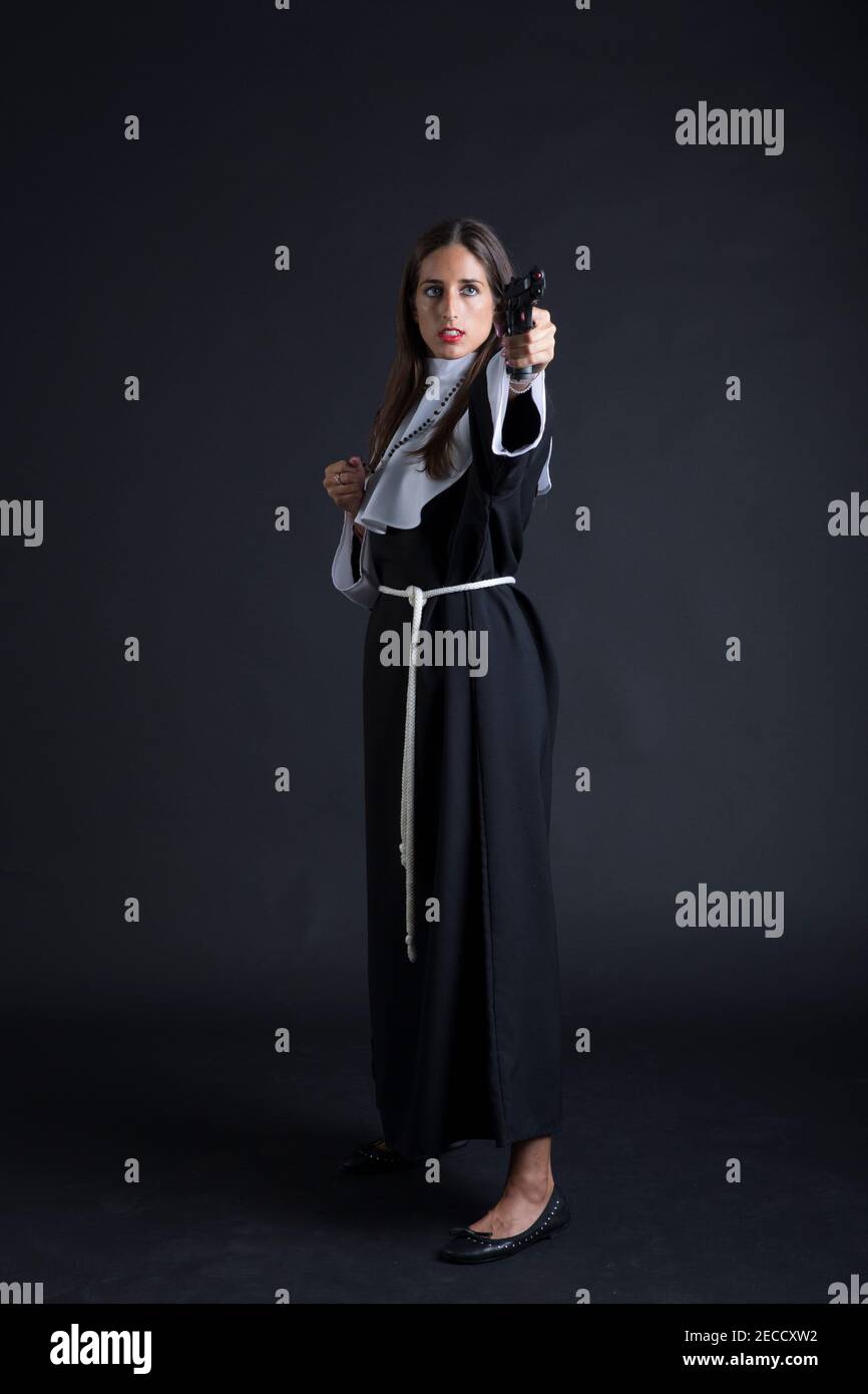 Portrait of a disguised nun on black background Stock Photo - Alamy