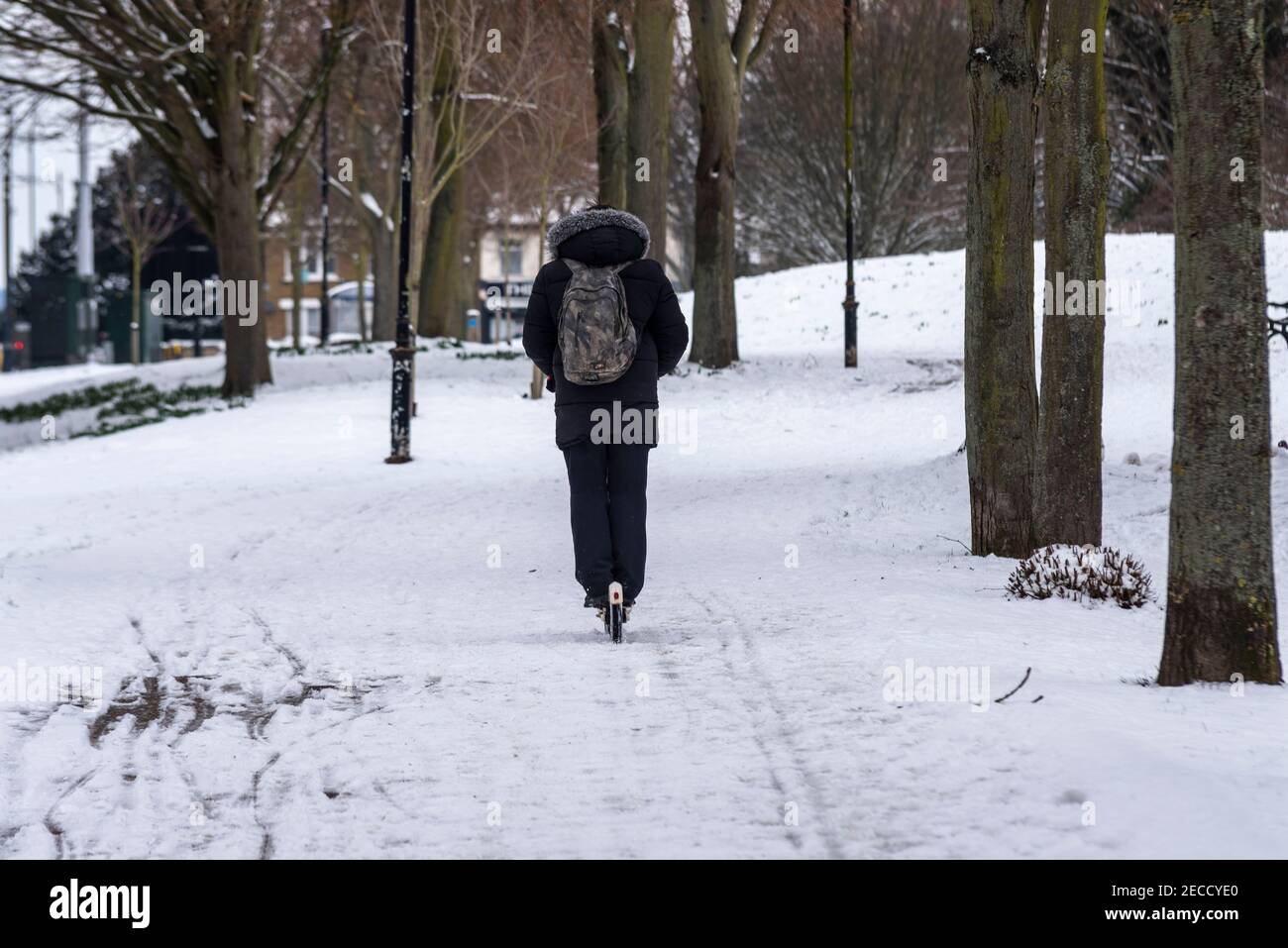 E scooter rider in Southend on Sea, Essex, UK, with snow from Storm ...