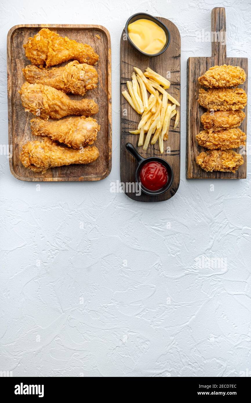 Homemade crispy fried chicken parts on white background, flat lay, with ...