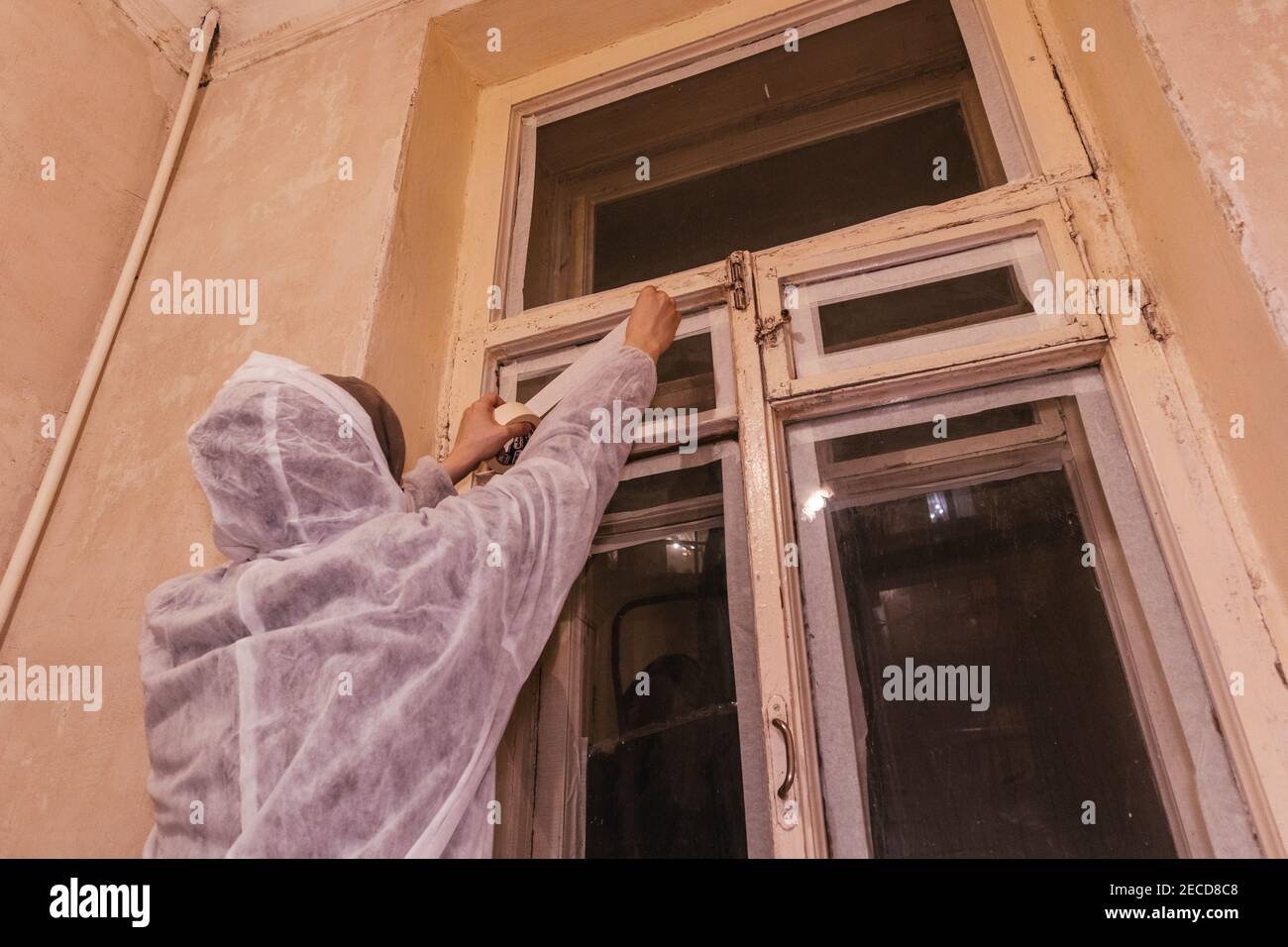worker painter prepares window to paint masking tape job Stock Photo ...