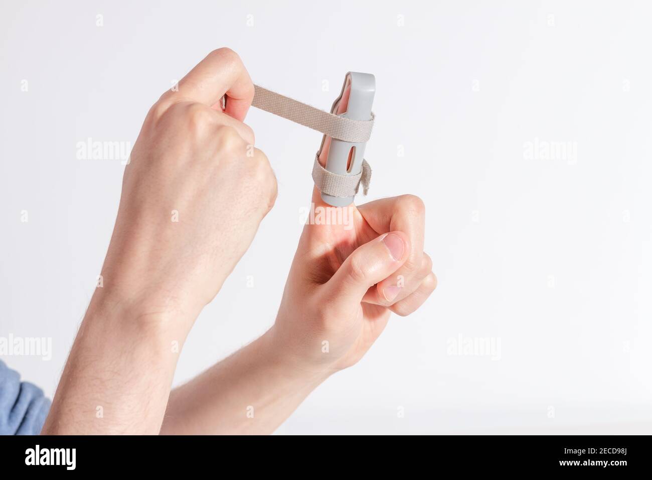 a man fixing Grey plastic two-sided Finger Splint with two hook-and ...