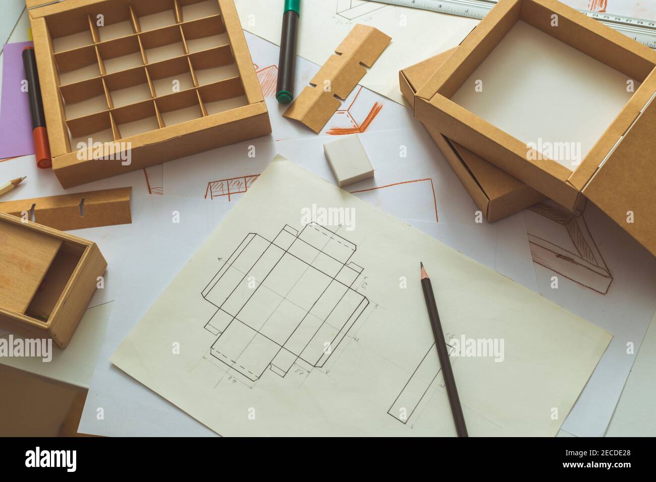 Engineer designer desktop. Drawings of sketches of packages Stock Photo ...