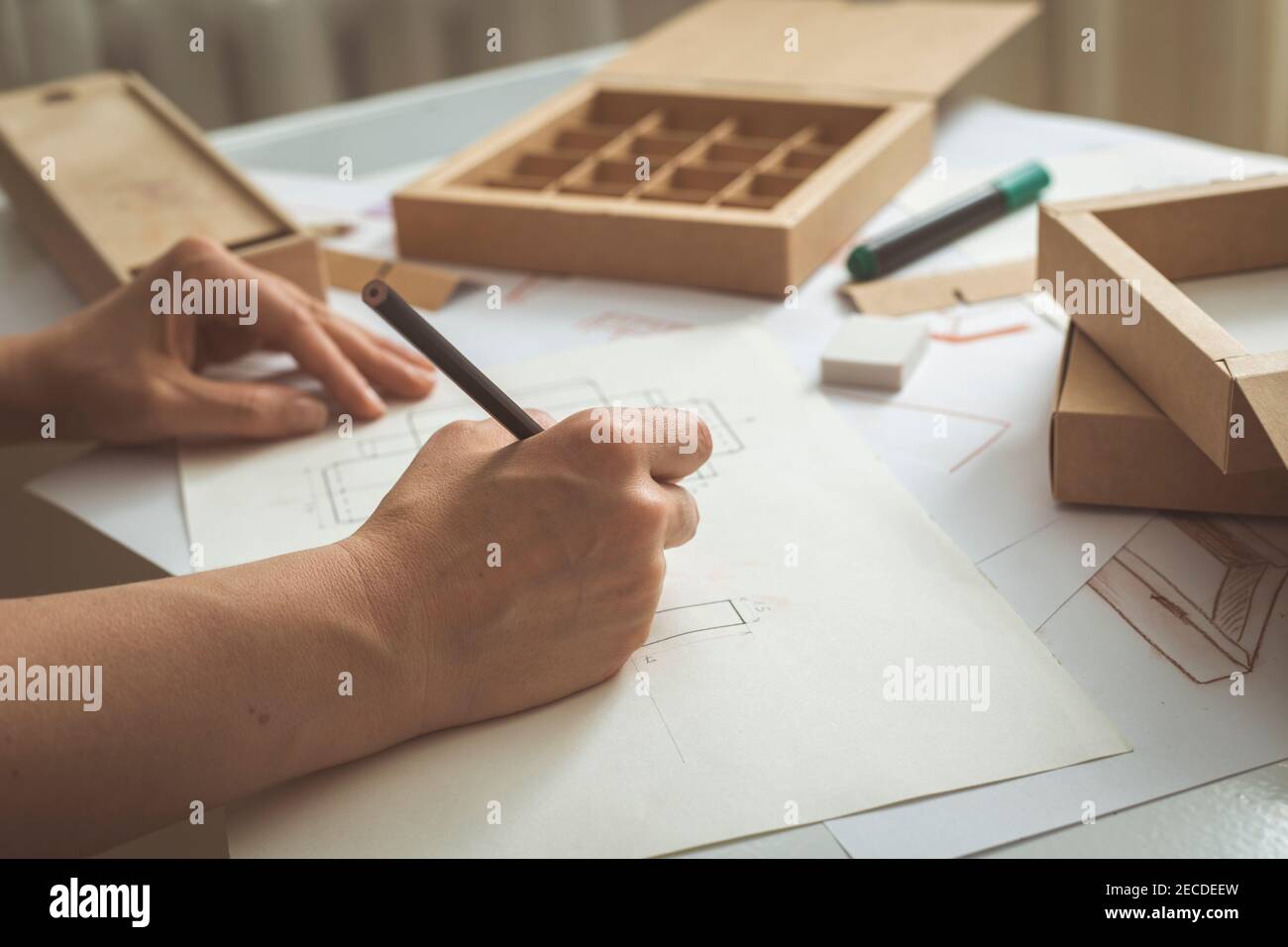 Engineer designer desktop. Drawings of sketches of packages Stock Photo ...