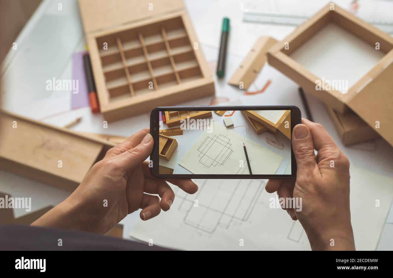 Engineer designer desktop. Drawings of sketches of packages Stock Photo ...