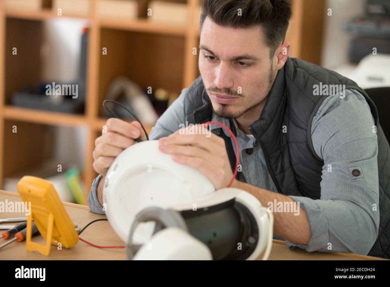 male technician using multimeter to test appliance Stock Photo - Alamy