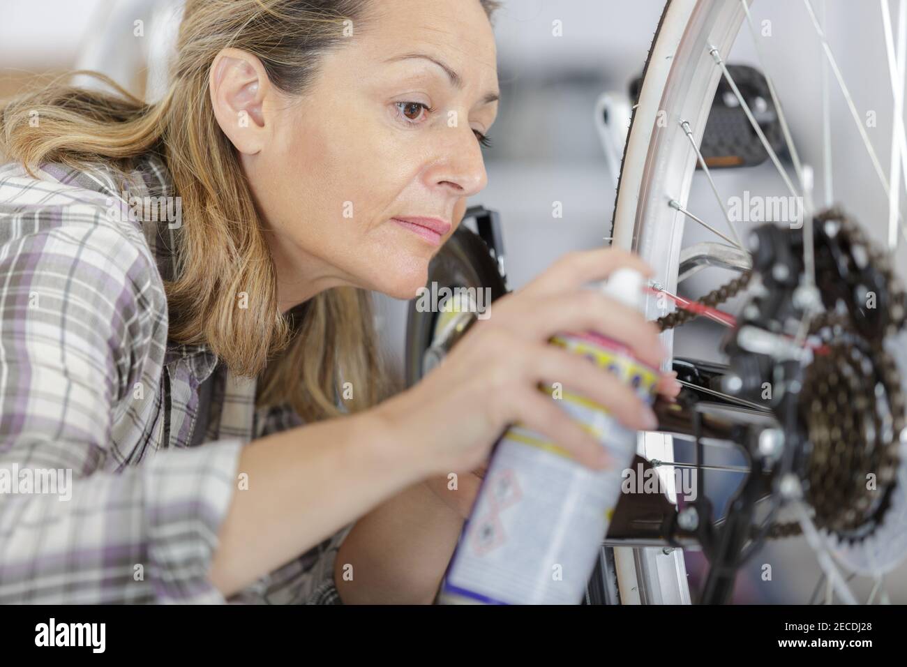 woman is oiling a bike Stock Photo - Alamy