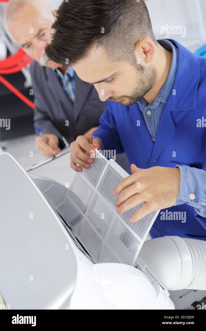 technician inspecting the filtration system Stock Photo - Alamy