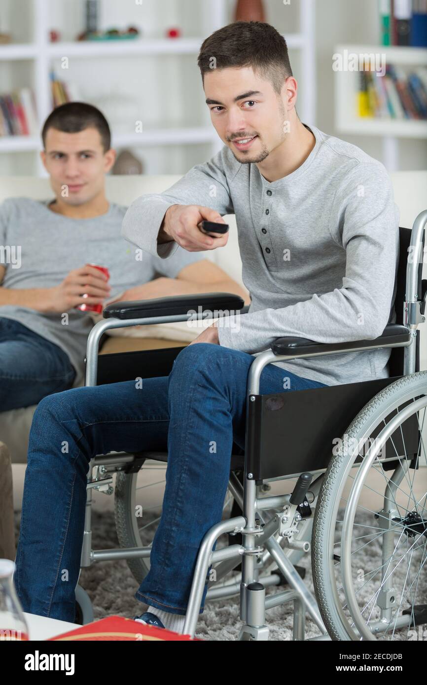 man on wheelchair changing the channel setting Stock Photo - Alamy