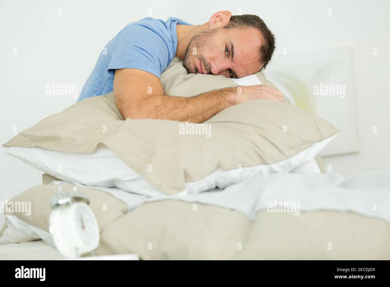 man lying in bed at home Stock Photo - Alamy