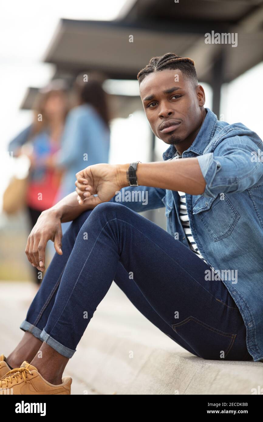 young man waiting train looking his watch Stock Photo - Alamy