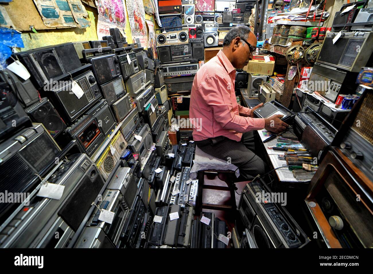 A radio mechanic seen working at his workshop surrounded with different ...