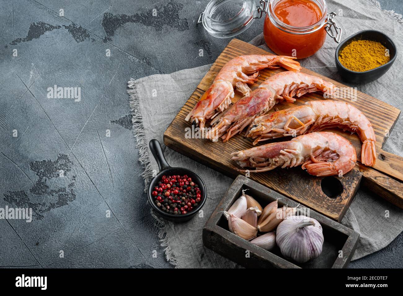 Large raw shell on raw king prawns set, on gray background , with ...