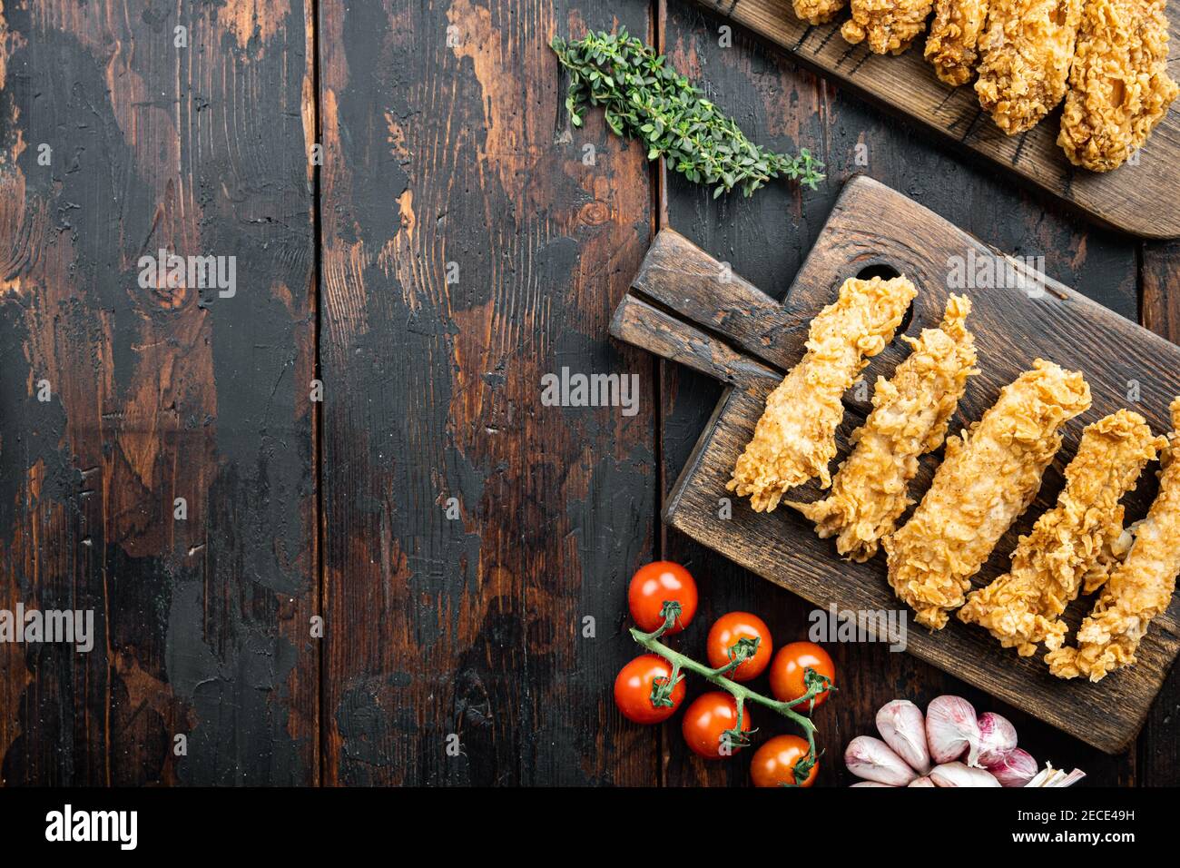 Homemade crispy fried chicken parts on old dark wooden table, top view ...