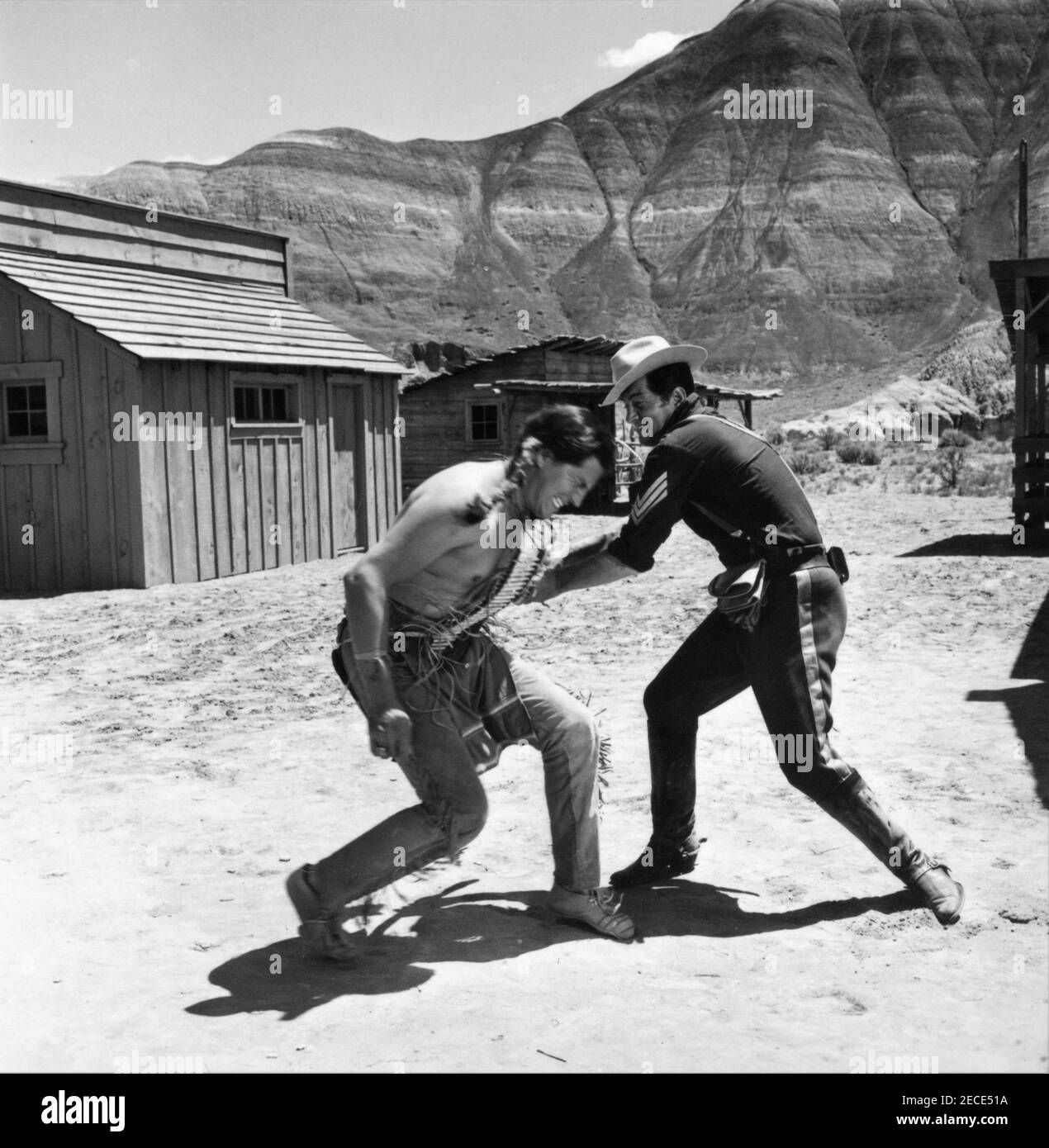 DEAN MARTIN rehearses a fight scene with Native American Indian on set ...